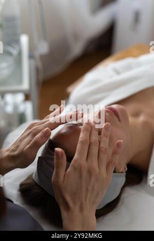 Close up photo of cosmetologist and client hands before rejuvenation ...