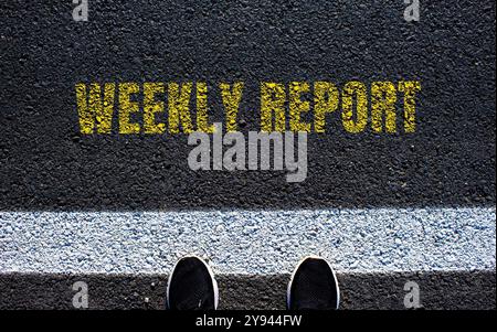 Weekly report message written on wooden blocks on green background ...