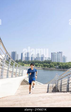 Young Chinese man jogging in a park Stock Photo - Alamy