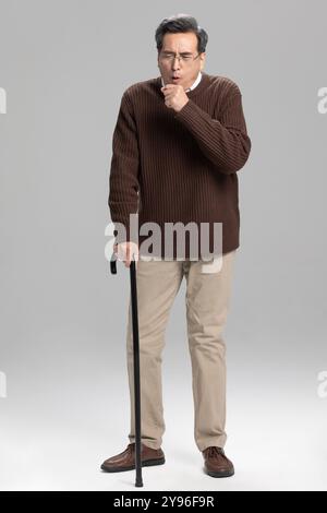 senior man feeling unwell and coughing as symptom for cold or ...