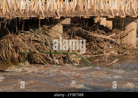 Debris from the violent flash floods stuck to the bridge Stock Photo ...