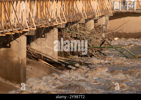 Debris from the violent flash floods stuck to the bridge Stock Photo ...