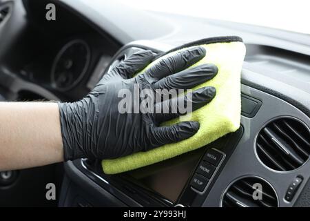Man cleaning center console with rag, closeup Stock Photo - Alamy