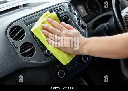 Man cleaning center console with rag, closeup Stock Photo - Alamy