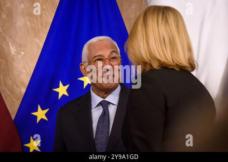 European Council President Antonio Costa, left, greets Latvia's Prime Minister Evika Silina as ...