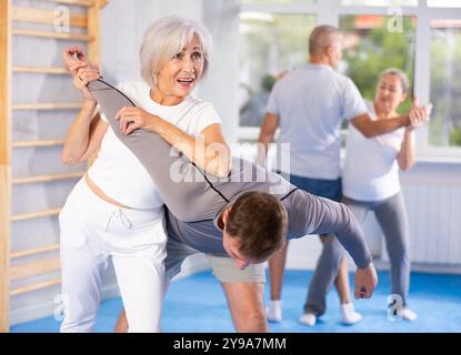 Old woman twisting her opponent's arm during self-defense classes Stock ...