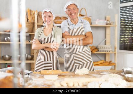 Two generations of successful bakers posing in family bakery Stock ...