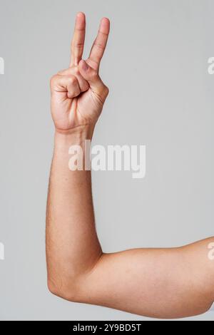 A person hand gesture against a neutral background Stock Photo - Alamy