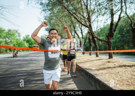 male runner almost crossing finish line Stock Photo - Alamy