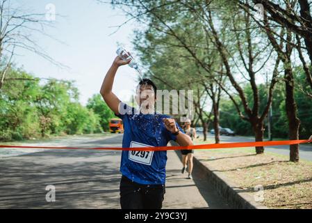 asian runner almost crossing finish line Stock Photo - Alamy