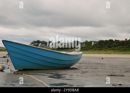 Blue Rowboat Beached And Resting On The Sand During Low Tide Stock ...