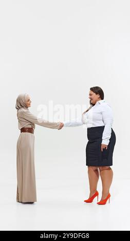Two businesswomen of different body types and cultural backgrounds ...