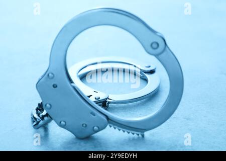 Classic chain handcuffs on table, space for text. Color toned Stock ...