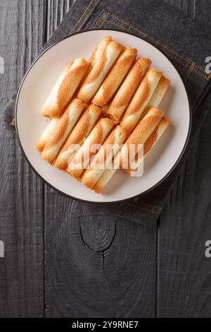 Delicious rolled wafer cookies on wooden table Stock Photo - Alamy