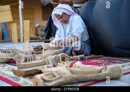 traditional Arabic carpenter (dhow maker) working in Katara cultural ...