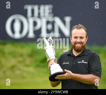 Shane Lowry holds the championship trophy as he celebrates with ...