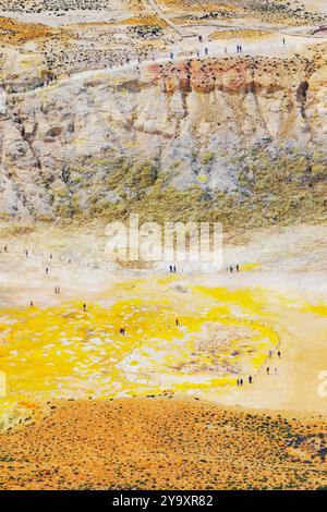 People walking around Stefanos crater moonlike landscape, Nisyros ...