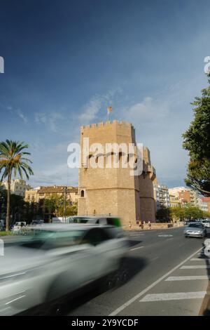 Stone fortress walls with arcade entrance and waving flag on a sunny ...