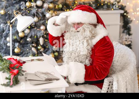 Shocked Santa Claus with letters at home on Christmas eve Stock Photo ...
