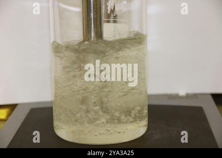 Homogenising a wastewater sample in the laboratory of a wastewater ...