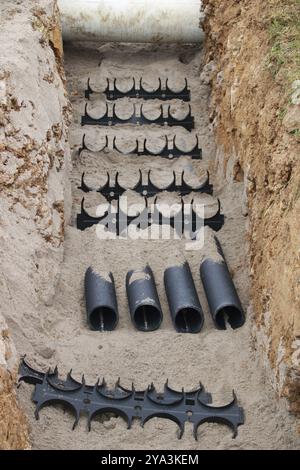 Empty conduits for cables lie in a trench Stock Photo - Alamy