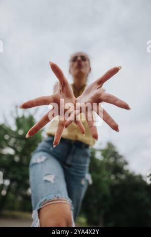Woman reaching out with both hands towards the viewer Stock Photo - Alamy