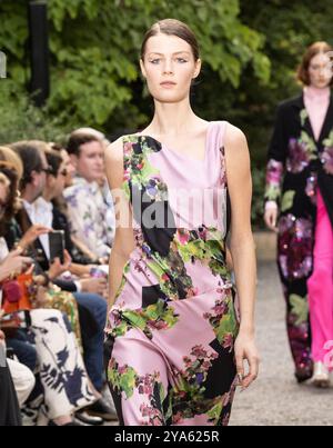 Designer Johnson Hartig walks on the runway at the Libertine fashion ...