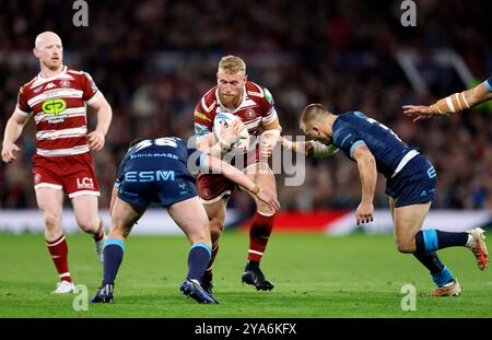 Wigan Warriors' Luke Thompson (centre) is tackled during the Betfred ...