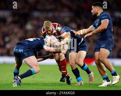 Wigan Warriors' Luke Thompson (centre) is tackled during the Betfred ...