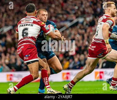 Wigan Warriors' Bevan French is tackled by St Helen's Joe Batchelor ...