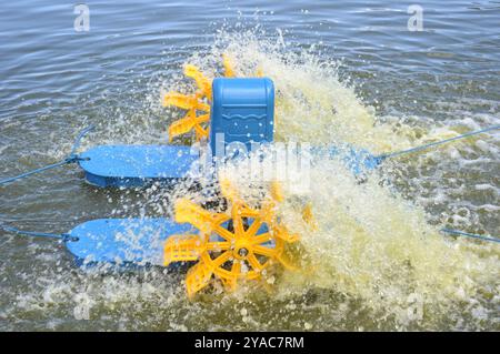 blue and yellow Waterwheel in a pond of shrimp Stock Photo - Alamy