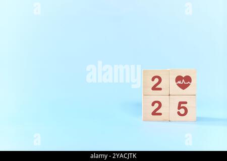 Year 2025 health priority concept. Wooden blocks on blue background ...