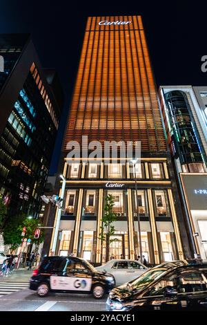 The high rise Cartier flagship store bathed in orange light on the ...
