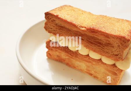 A delectable slice of mille-feuille pastry featuring layers of crispy ...
