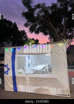 A decorated Sukkah set up on the street for the Jewish holiday of ...