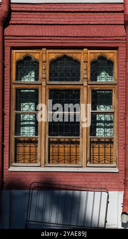 Exterior view of a large brick ruin with arched openings and an olive ...