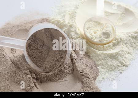 Protein powders and scoops on white background, closeup Stock Photo - Alamy