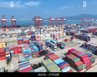 Cargo ships load and unload containers at Qingdao Port in east China's ...