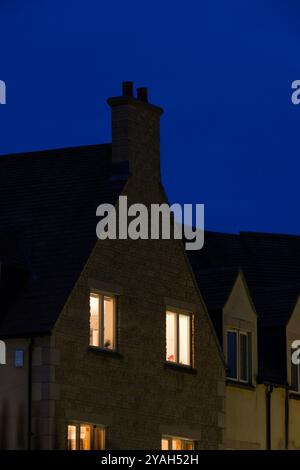 Lights shining through the window of a house at night Stock Photo - Alamy