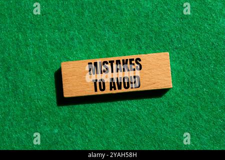 Mistakes to avoid message written on ripped paper with red background ...