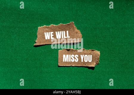 We will miss you message written on ripped torn cardbaord paper piece with red background ...