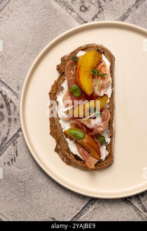 Sandwich with cream cheese, prosciutto and peach Stock Photo - Alamy