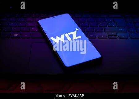 In this photo illustration, the Wiz logo is displayed on a smartphone ...