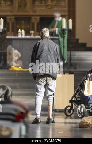 A mentally confused homeless man in the church, family mass with ...