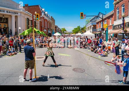 Crowd enjoys a busker show during the Buskerfest in downtown Dundas ...