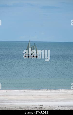 A classic sailing yacht passes an idyllic beach in Florida USA Stock ...