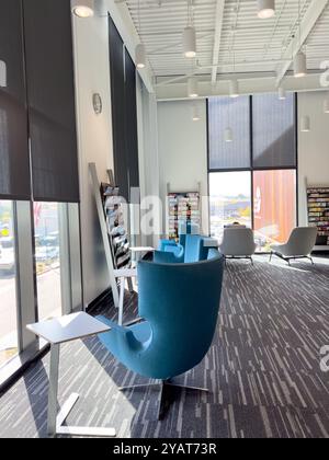 Modern Library Lounge with Bright Orange Chairs and Glass-Enclosed ...