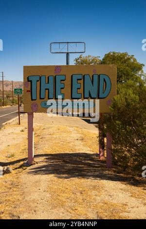 An odd scene with The End sign in front of a tall empty sign in Morongo ...