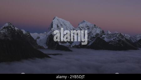 Nightfall in the Himalayas. Pink sky over Mount Cholatse and Tobuche ...