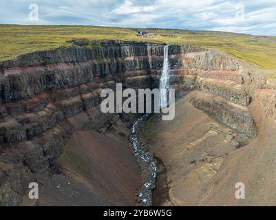 Waterfall Hengifoss, basaltic layers interwoven with red sedimentary ...
